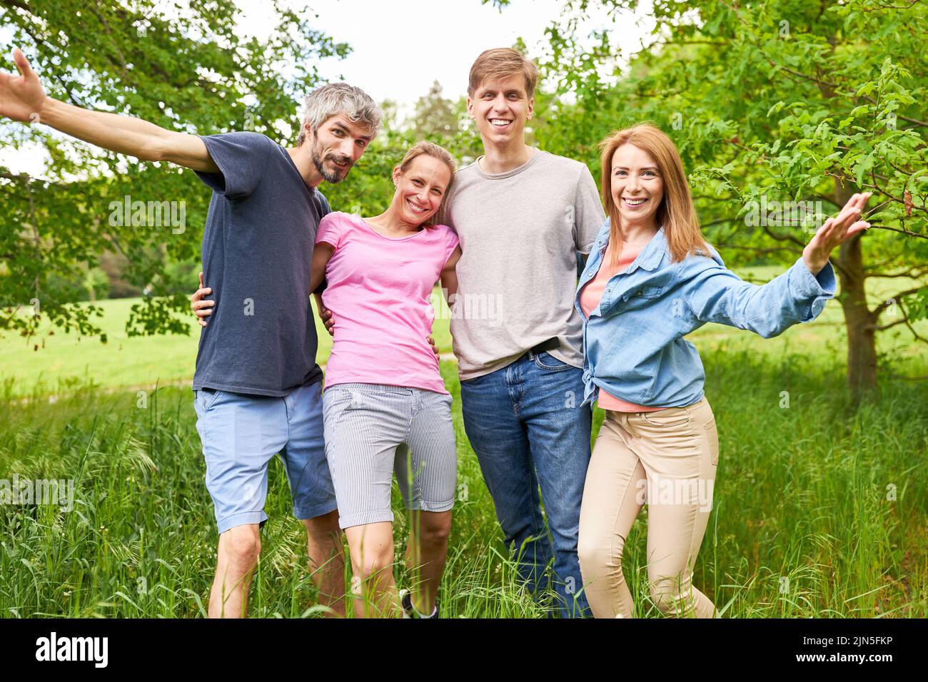 Group of friends or siblings have fun on a trip in nature on summer ...