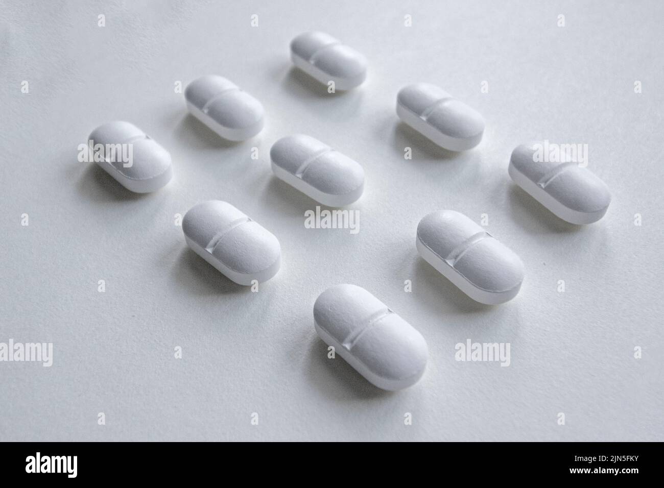 White tablets shot on white background Stock Photo - Alamy