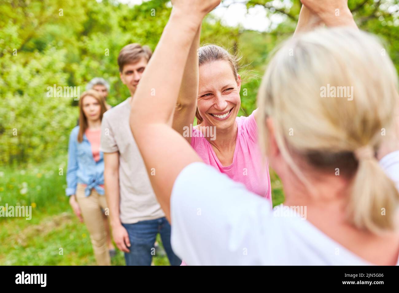 Happy woman high five with team colleagues after success in outdoor ...