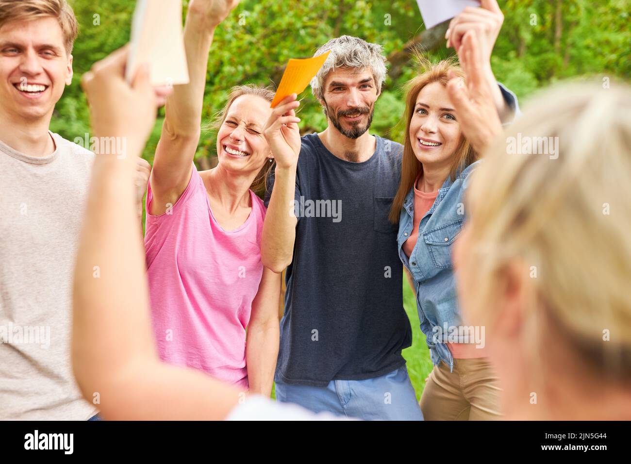 Group of young people in creative team building workshop using colorful ...