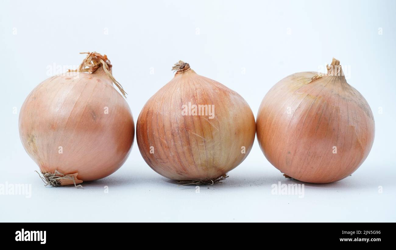 Three Onions isolated on white background Stock Photo - Alamy