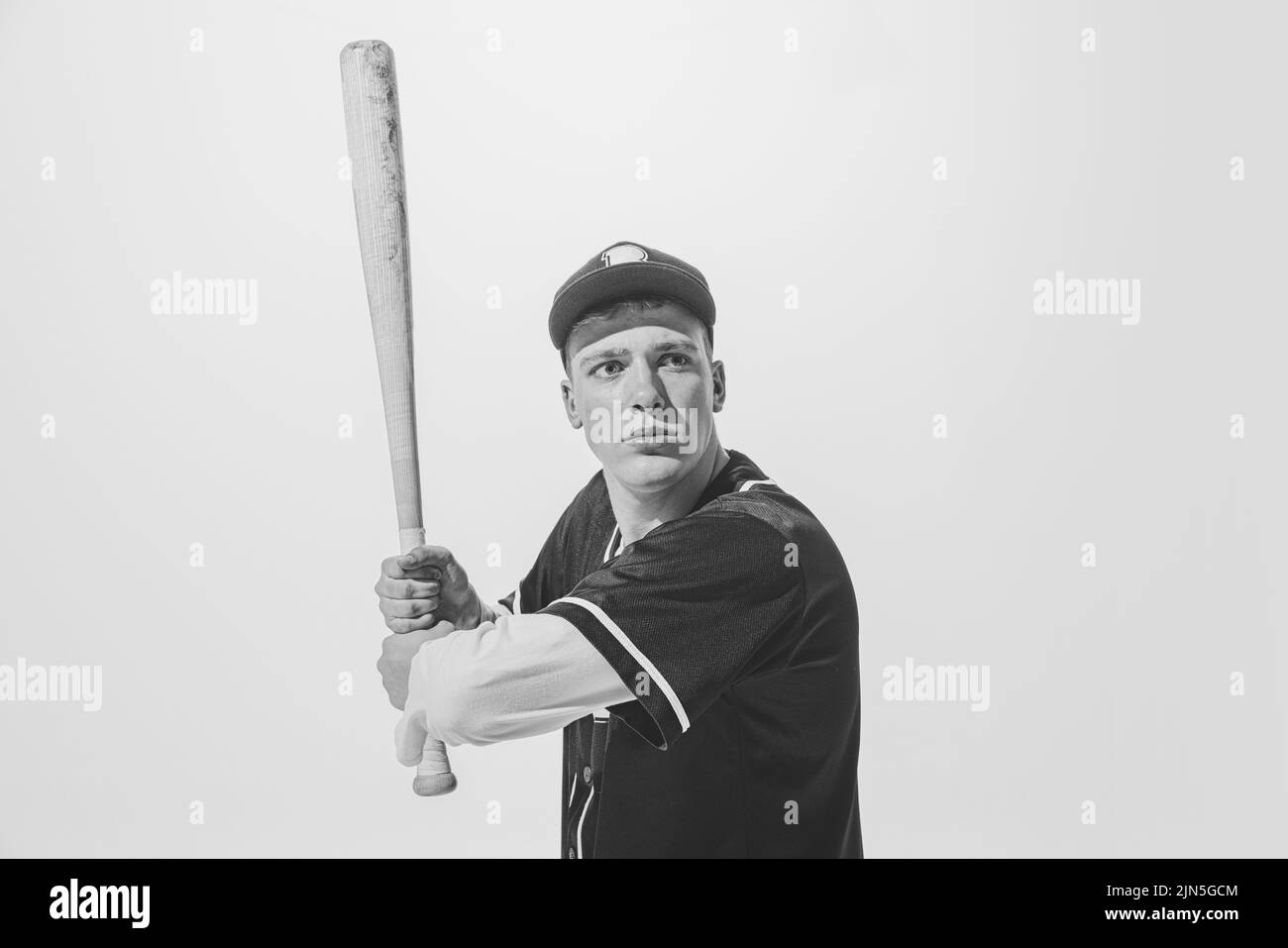 Black and white portrait of concentrated young man, baseball player in ...