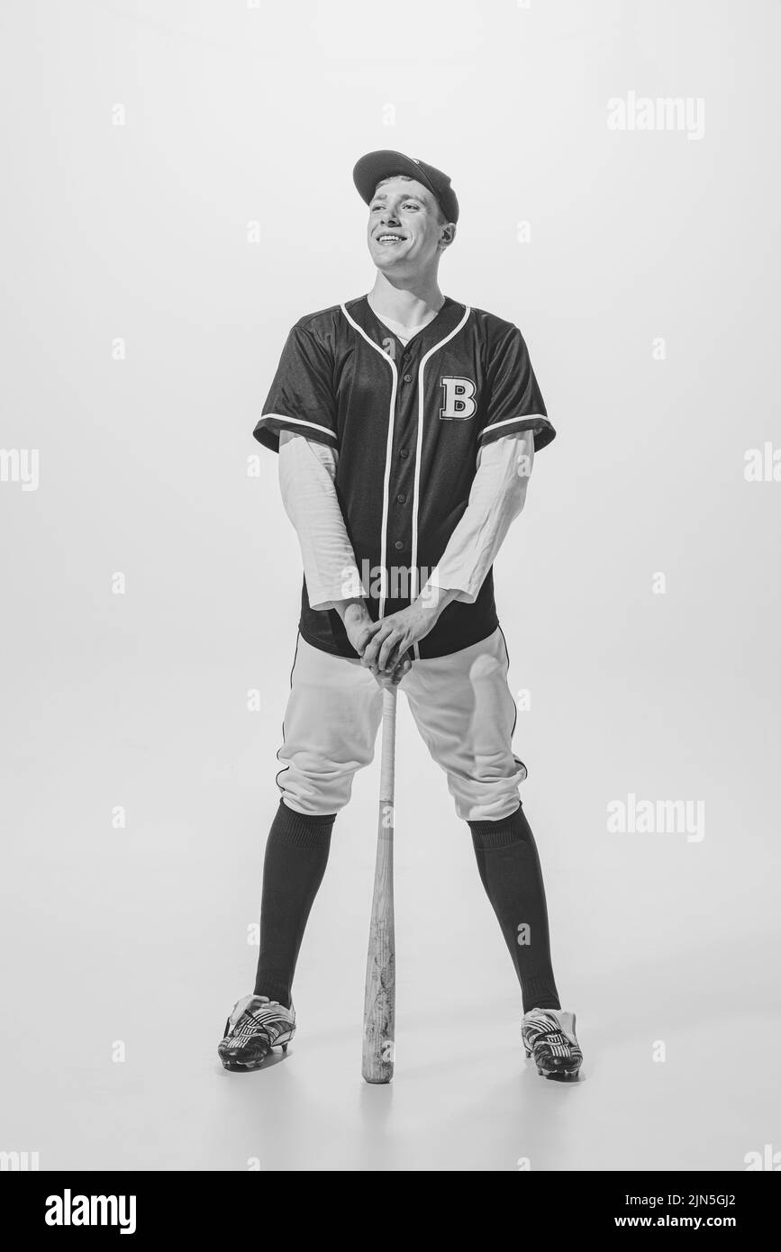 Full-length portrait of young man, college student, baseball player ...