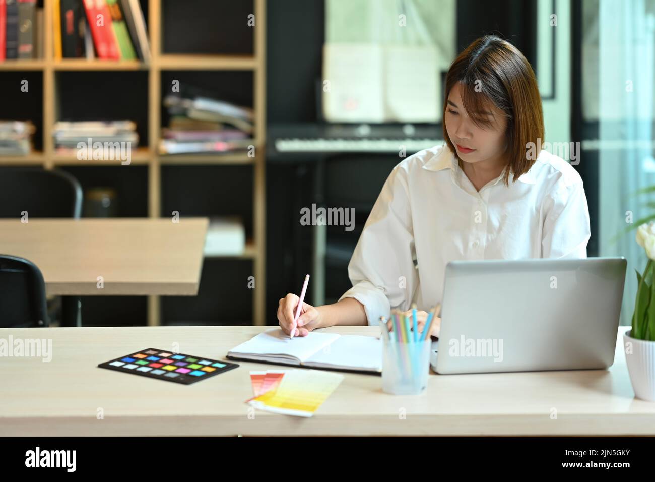 Focused asian woman working hi-res stock photography and images - Alamy