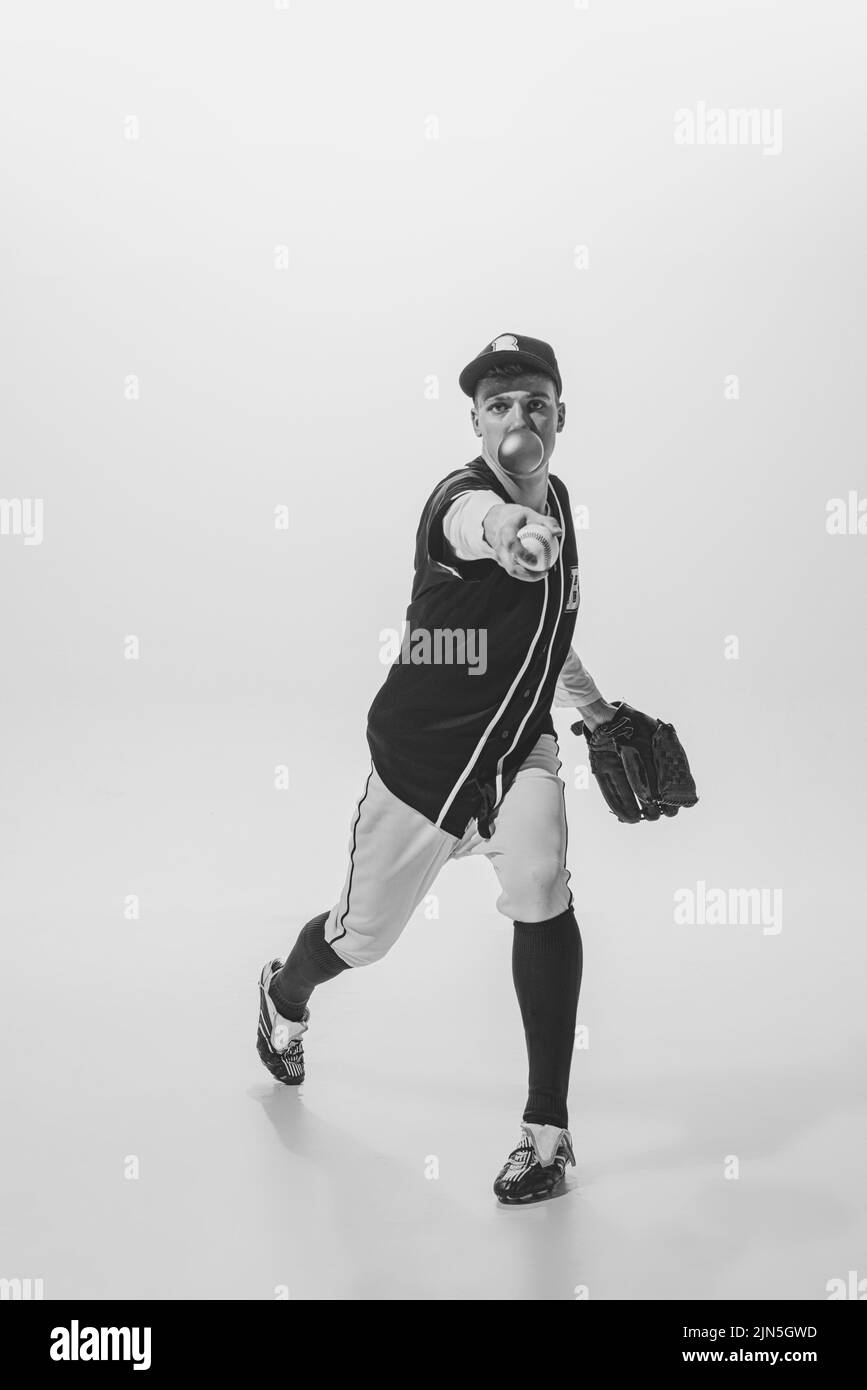 Portrait of young man, baseball player, pitcher with bubblegum playing ...