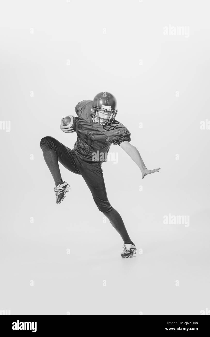 Dynamic portrait of young sportive man, american football player in ...