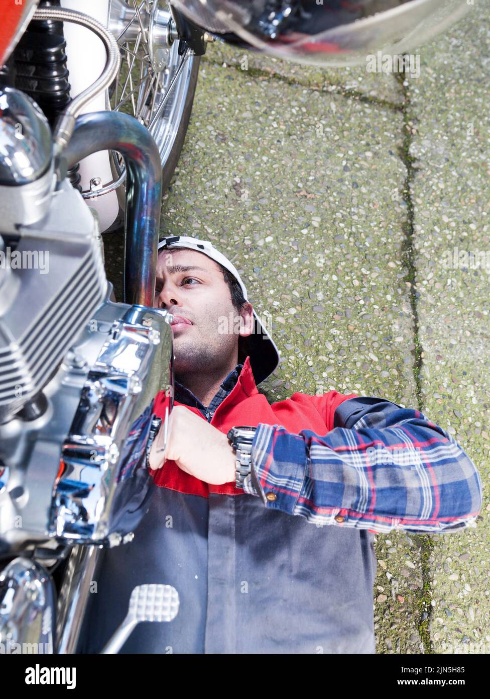 young mechanic repairing a vintage motorcycle Stock Photo - Alamy