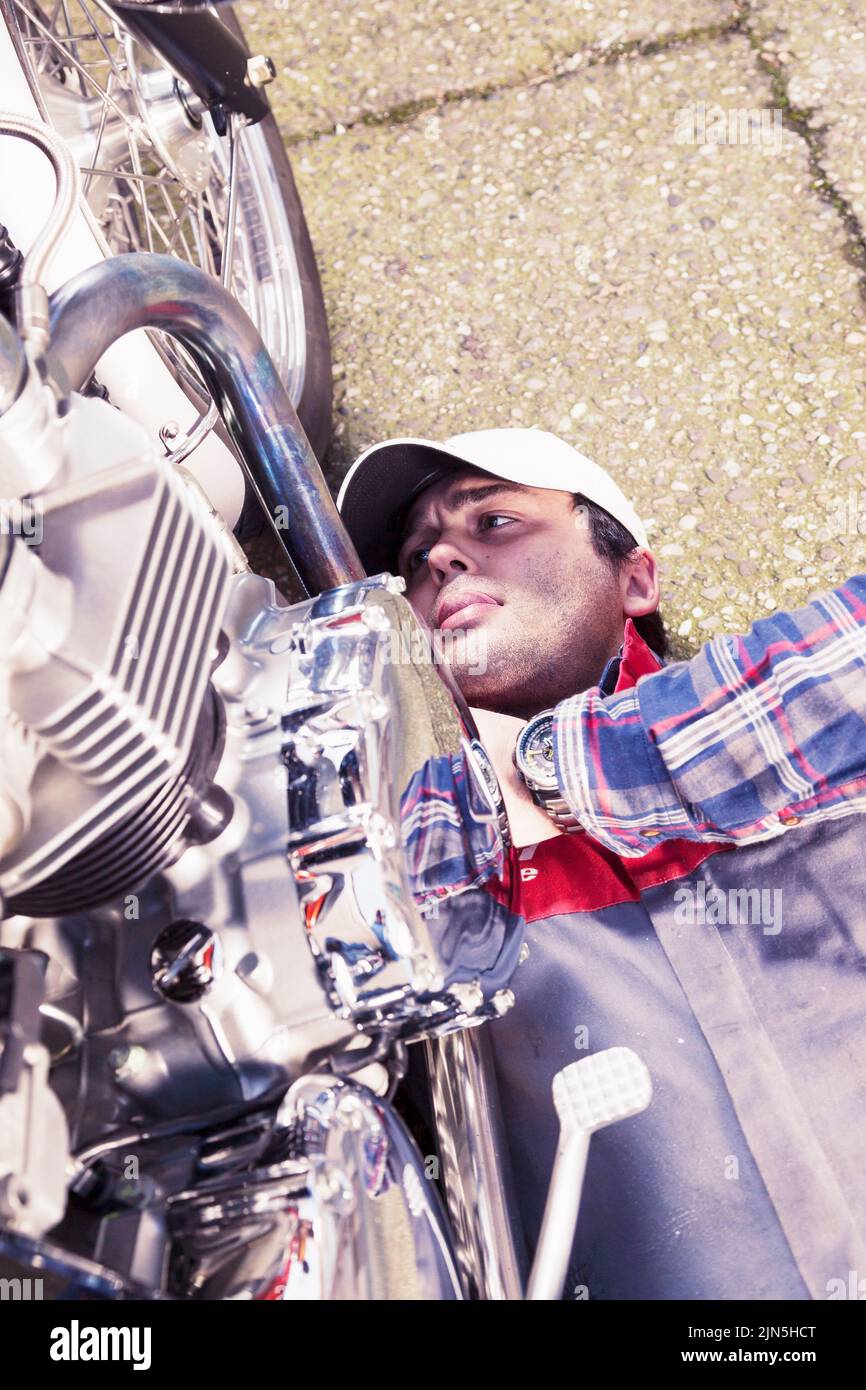 young mechanic repairing a vintage motorcycle Stock Photo - Alamy