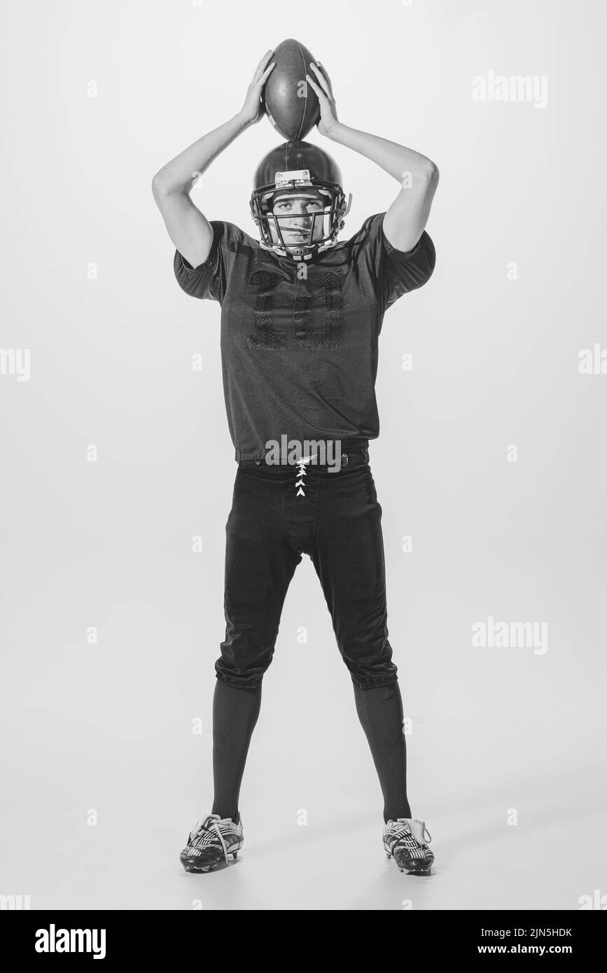 Portrait of young man, american football player posing. Black and white ...