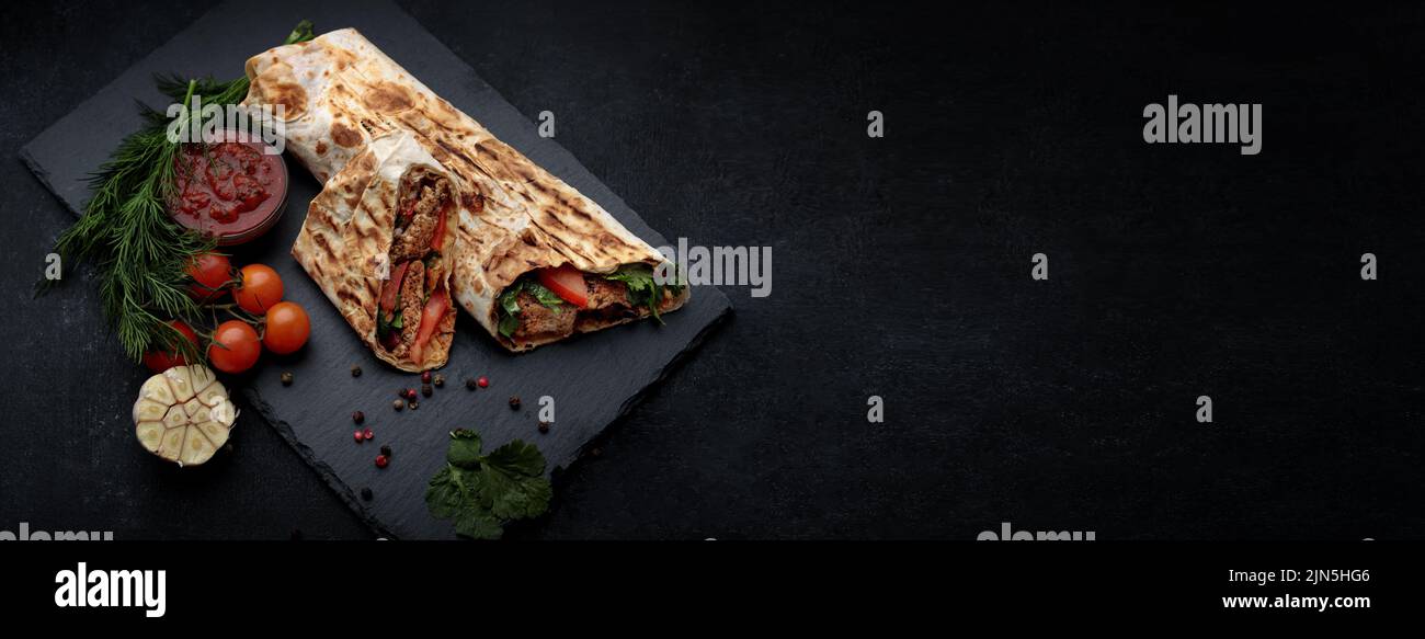 Shawarma with meat, cutaway, with sauce, tomatoes, cheese, herbs and ...