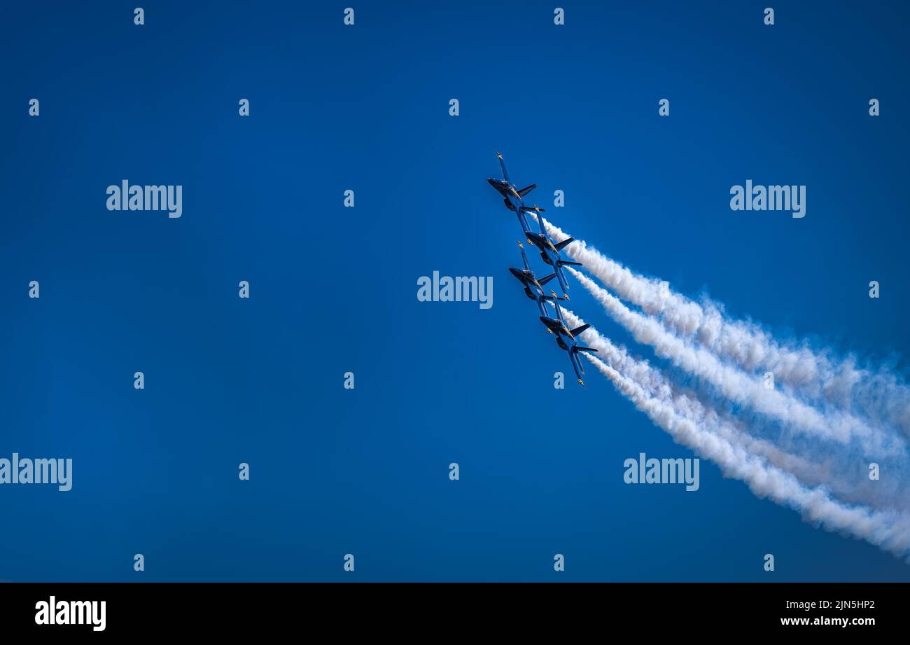 A beautiful shot of four blue angle jets flying with smoke trailing the ...