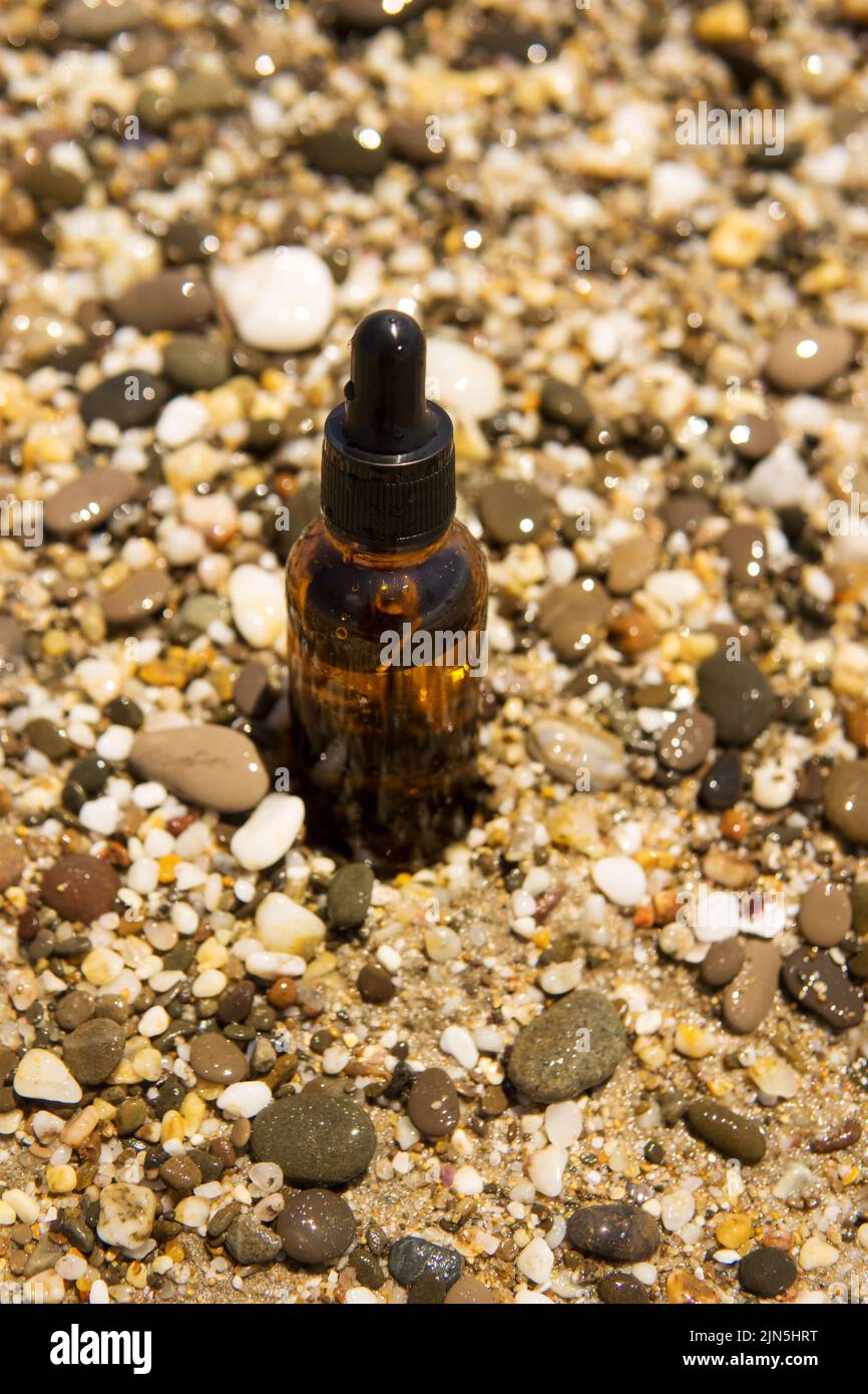Cosmetic serum for the skin in a glass bottle. A bottle with an ...