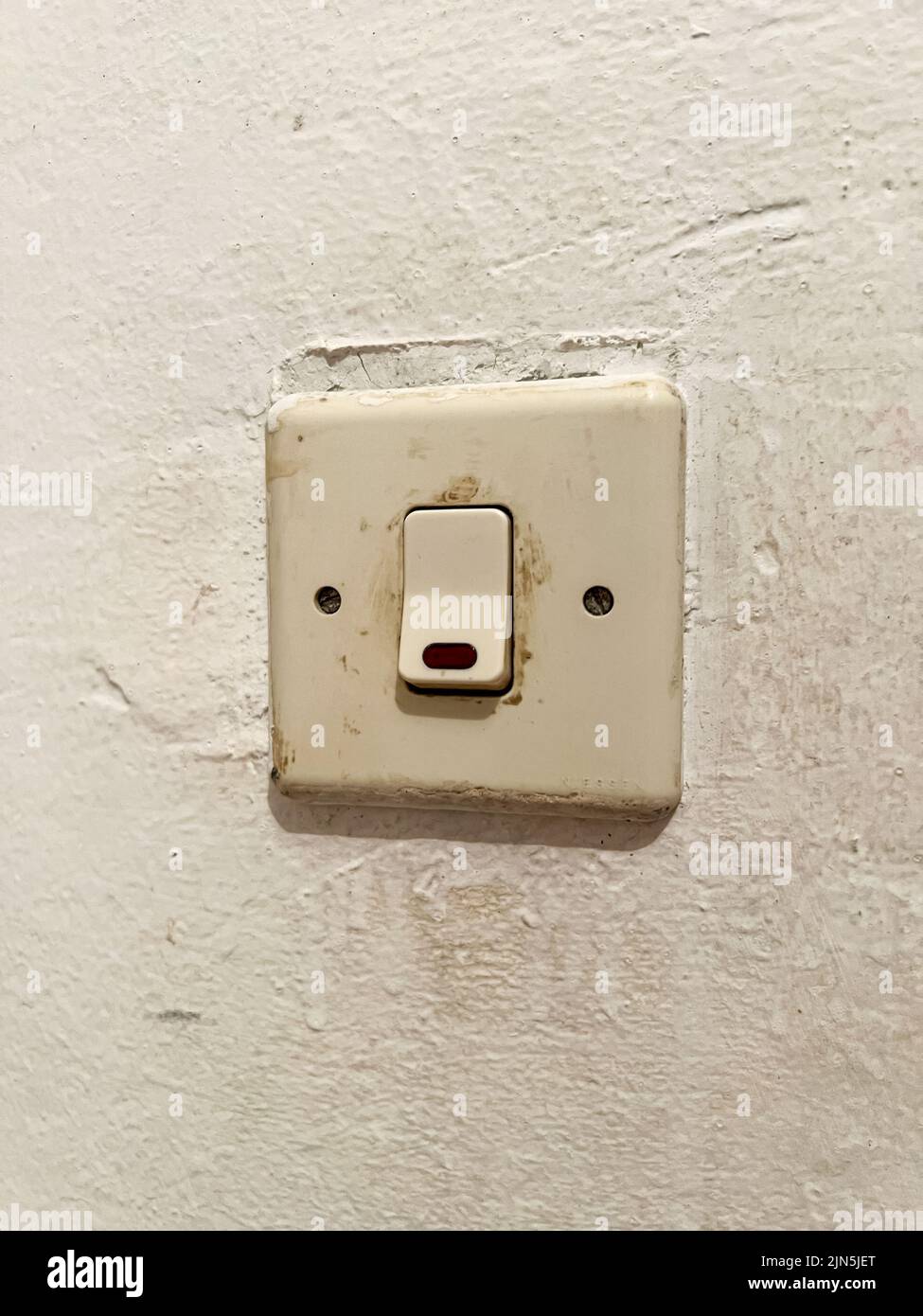 An old fashioned light switch mounted on a white wall Stock Photo - Alamy