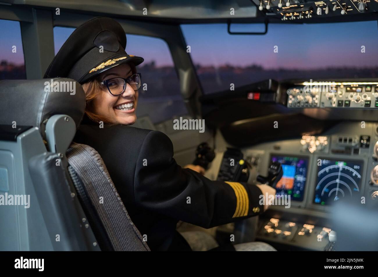 Female pilot on board the aircraft. Caucasian woman in flight simulator ...