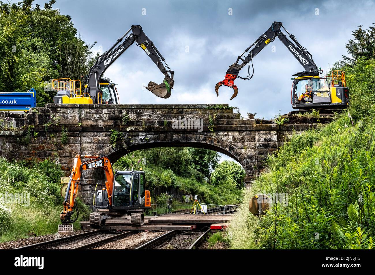 Railway workers building new railway and knocking down bridges Stock ...