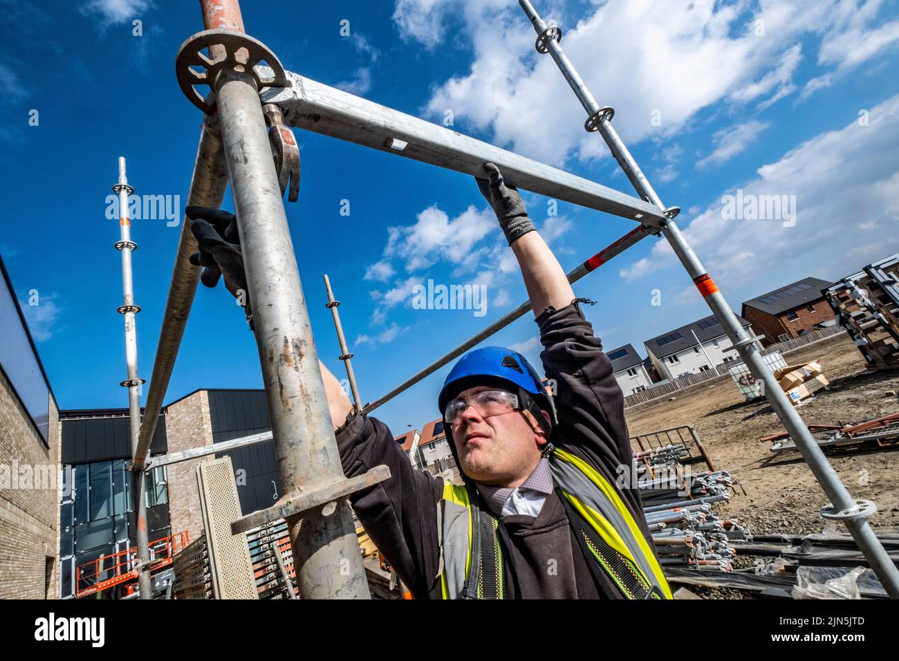 Construction workers in action on construction site Stock Photo - Alamy