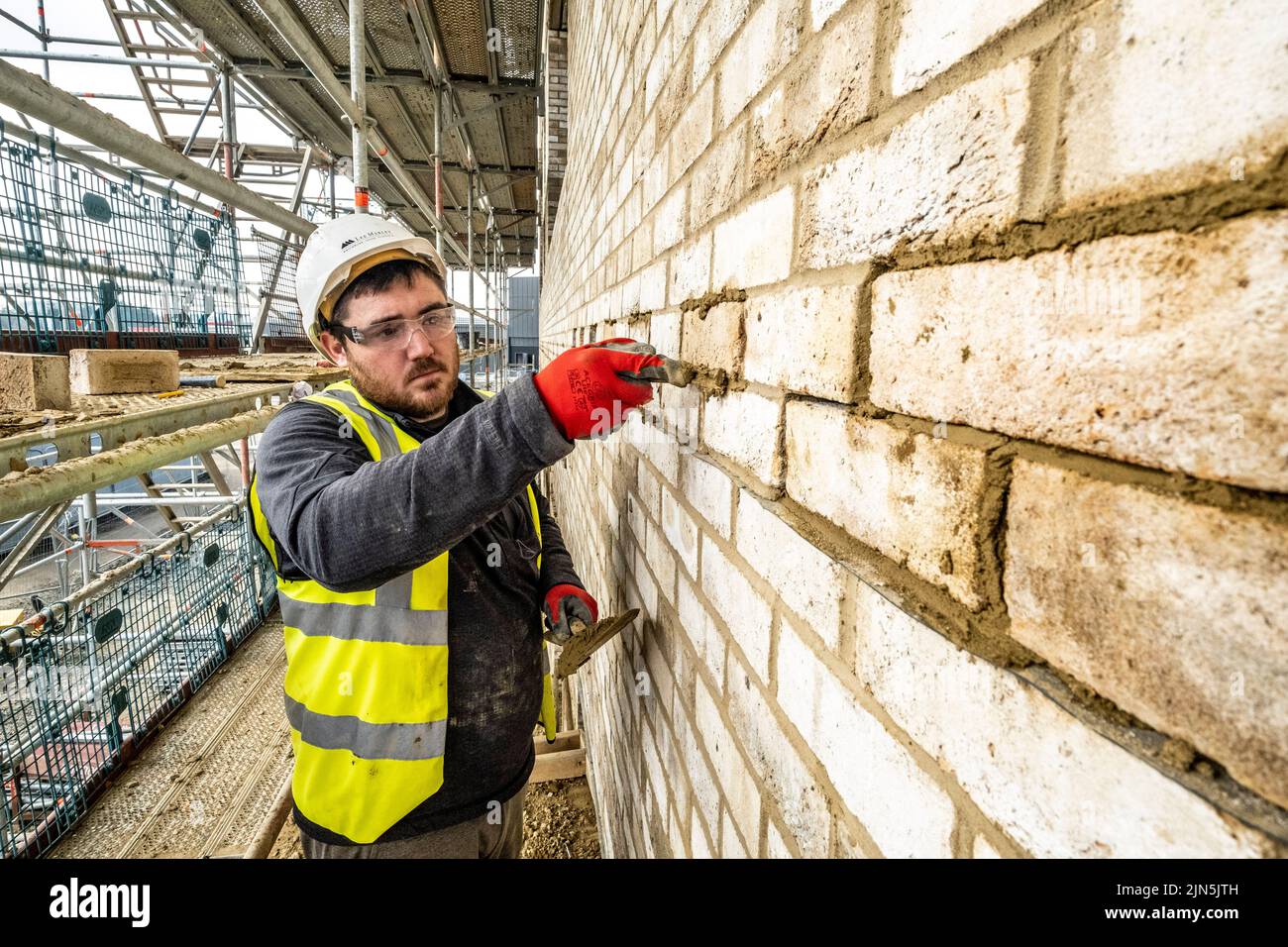 Construction workers in action on construction site Stock Photo - Alamy