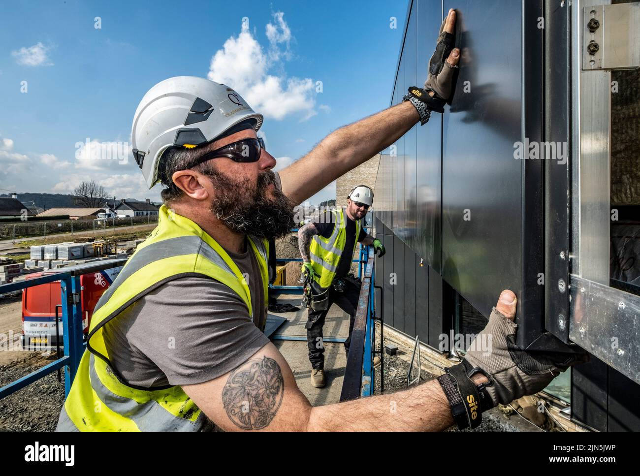 Construction workers in action on construction site Stock Photo - Alamy