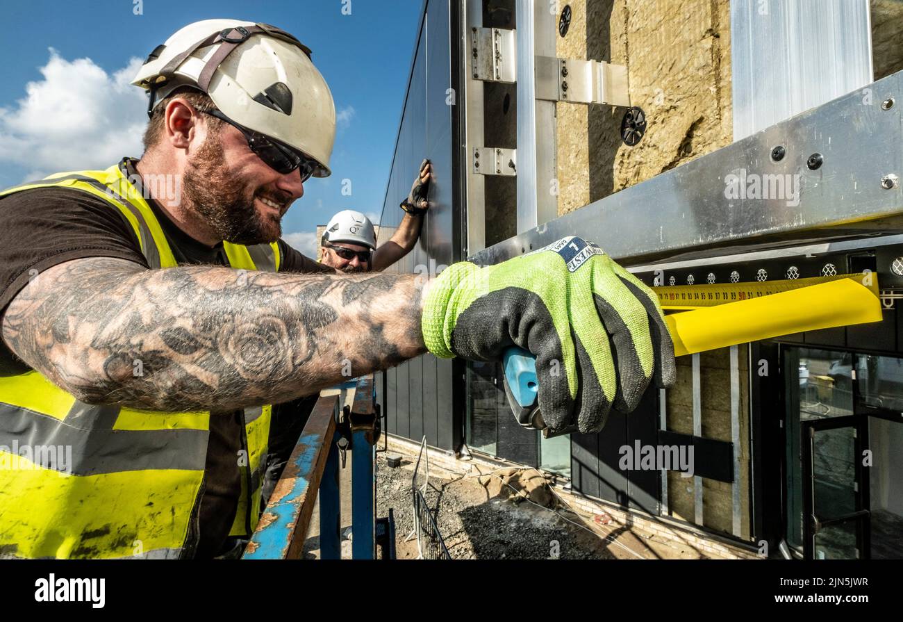 Construction workers in action on construction site Stock Photo - Alamy