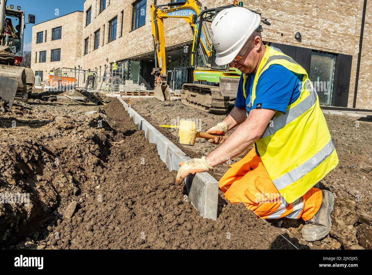 Construction workers in action on construction site Stock Photo - Alamy