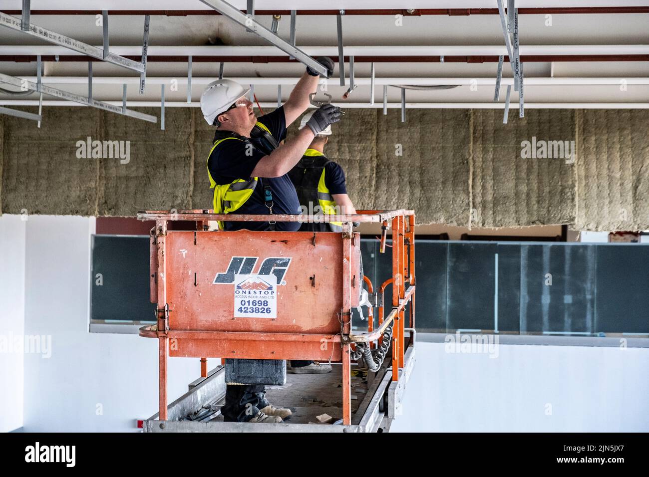 Construction workers in action on construction site Stock Photo - Alamy