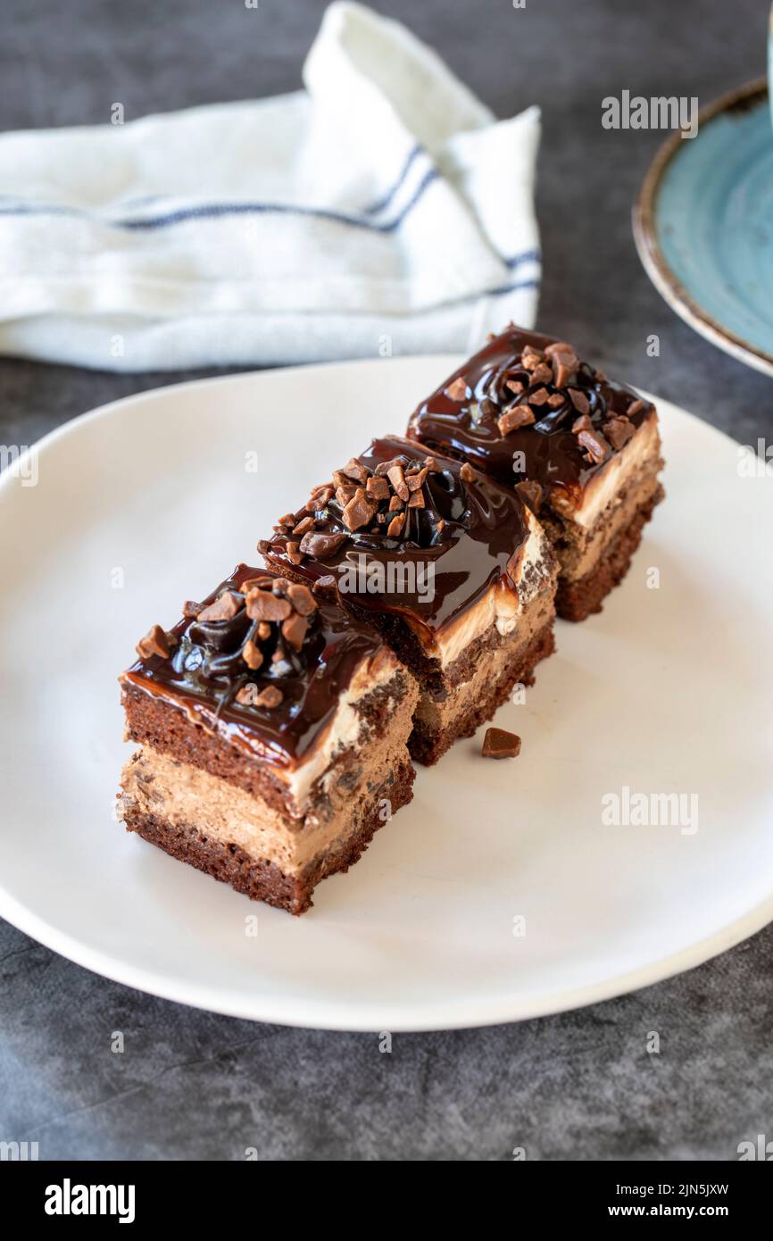 Chocolate tartlet. Small chocolate cake in a plate. On dark floor ...