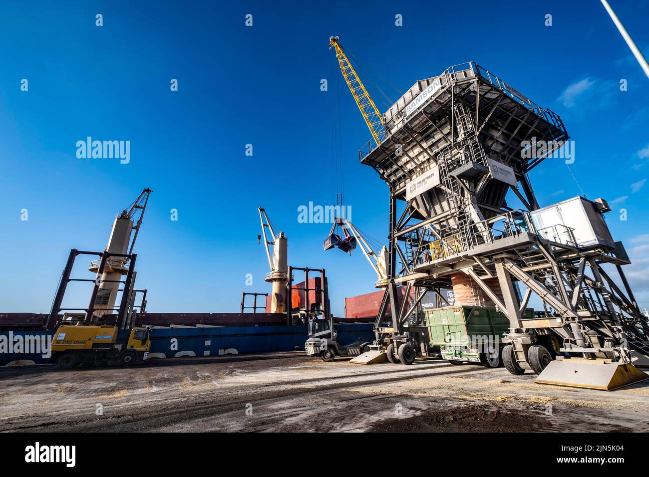 Grain being unloaded into a hopper at port Stock Photo - Alamy