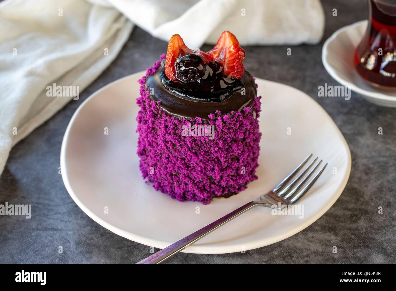 Fruit cake. Cake prepared with forest fruits on a plate. On dark ...