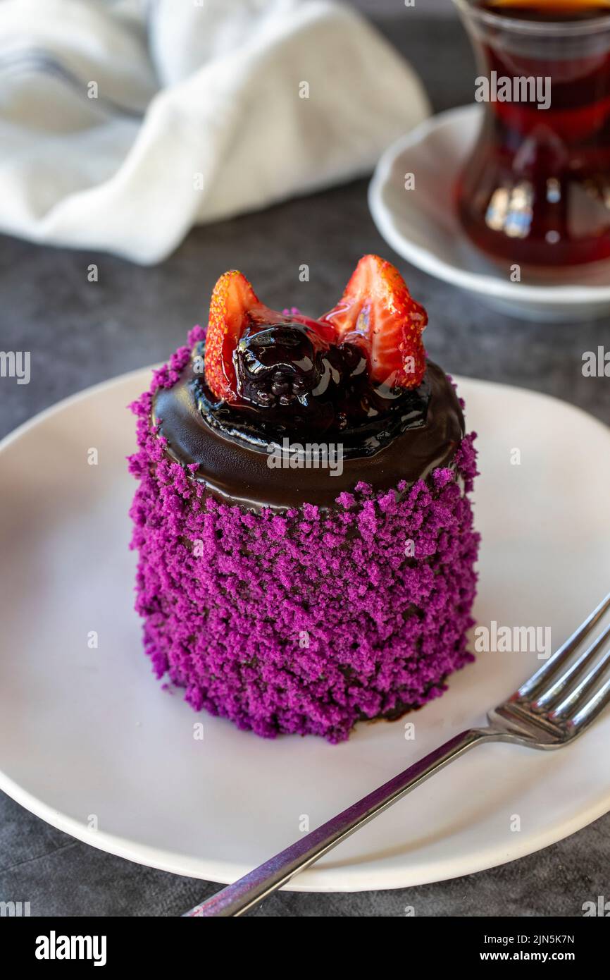 Fruit cake. Cake prepared with forest fruits on a plate. On dark ...