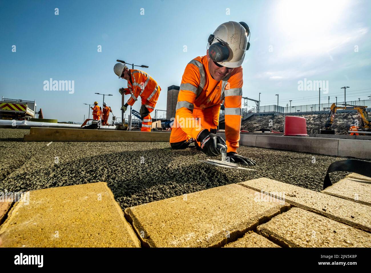 Railway workers building new railway and knocking down bridges Stock ...