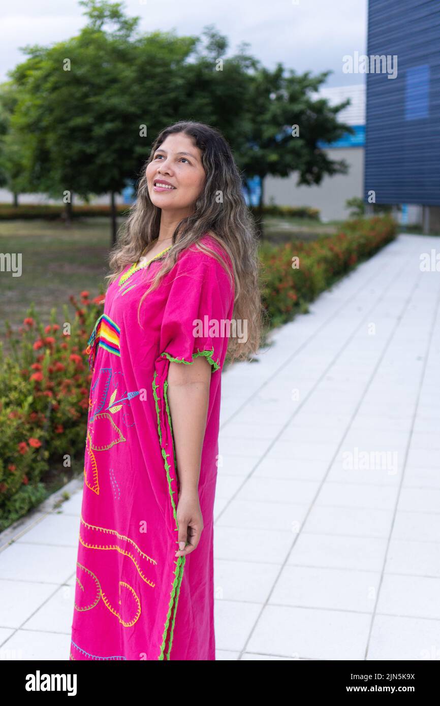 woman walking in traditional clothing in a city park Stock Photo - Alamy