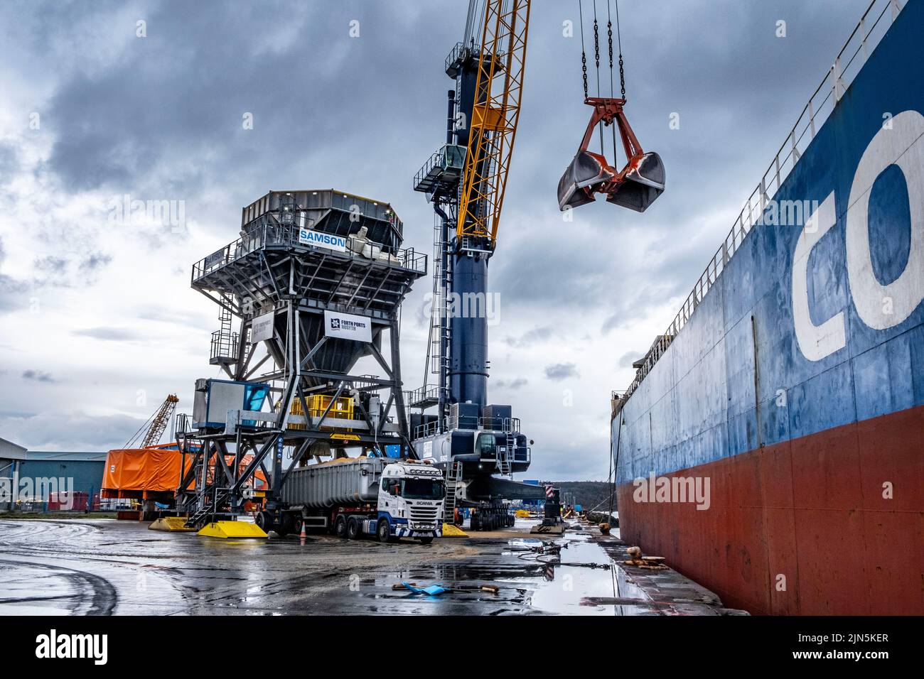 Grain being unloaded into a hopper at port Stock Photo - Alamy