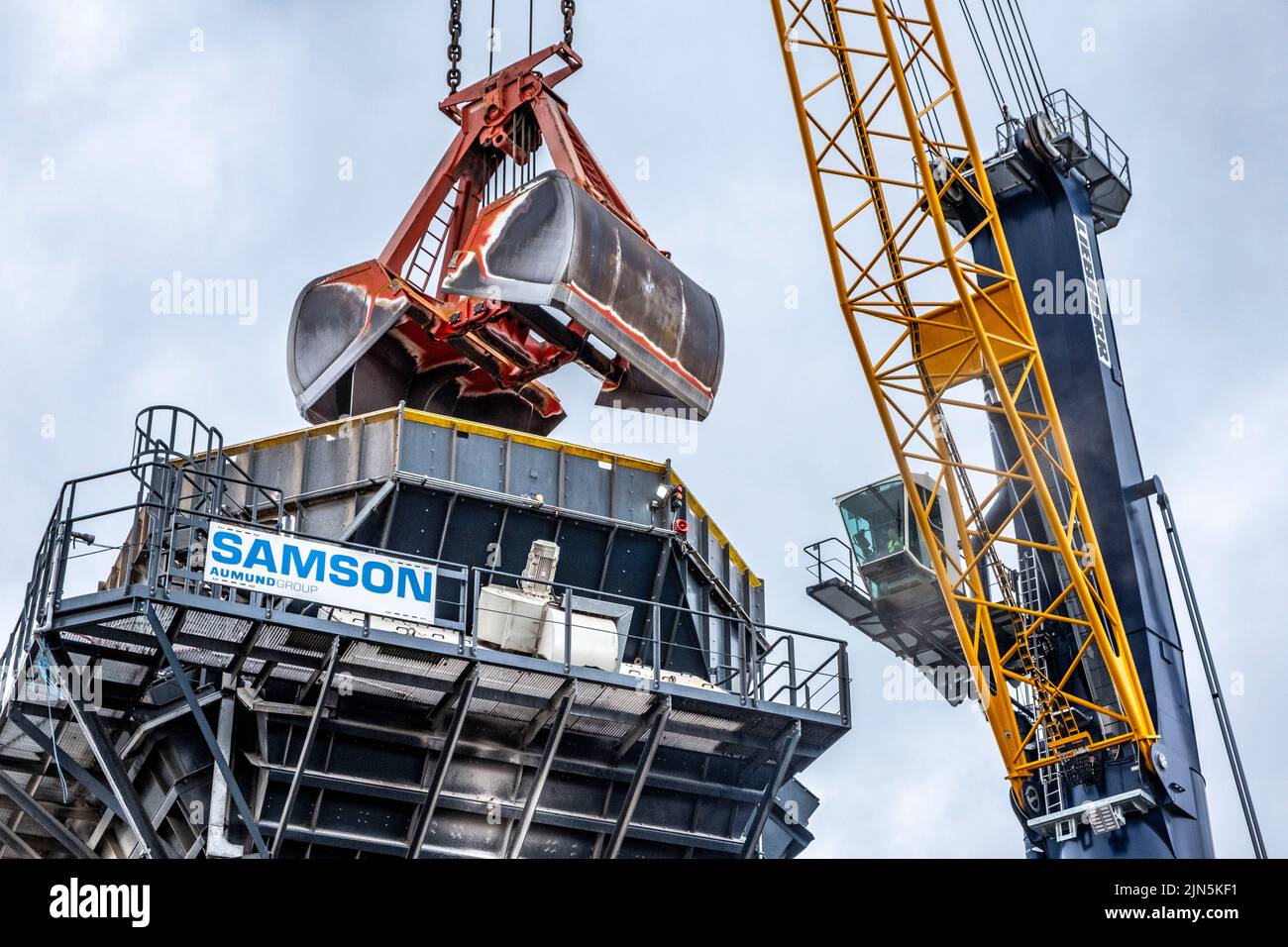 Grain being unloaded into a hopper at port Stock Photo - Alamy
