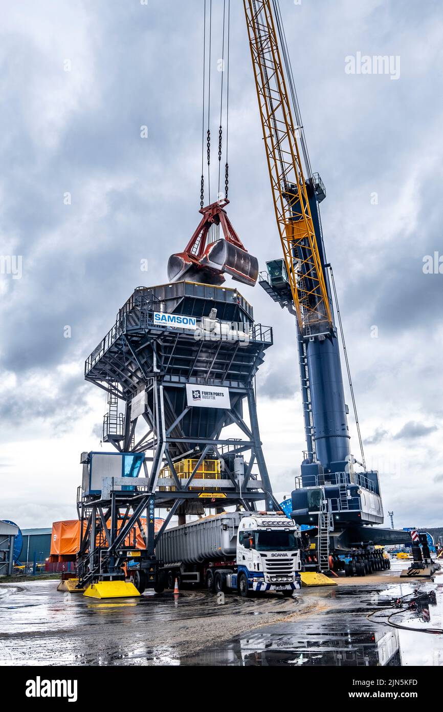 Grain being unloaded into a hopper at port Stock Photo - Alamy
