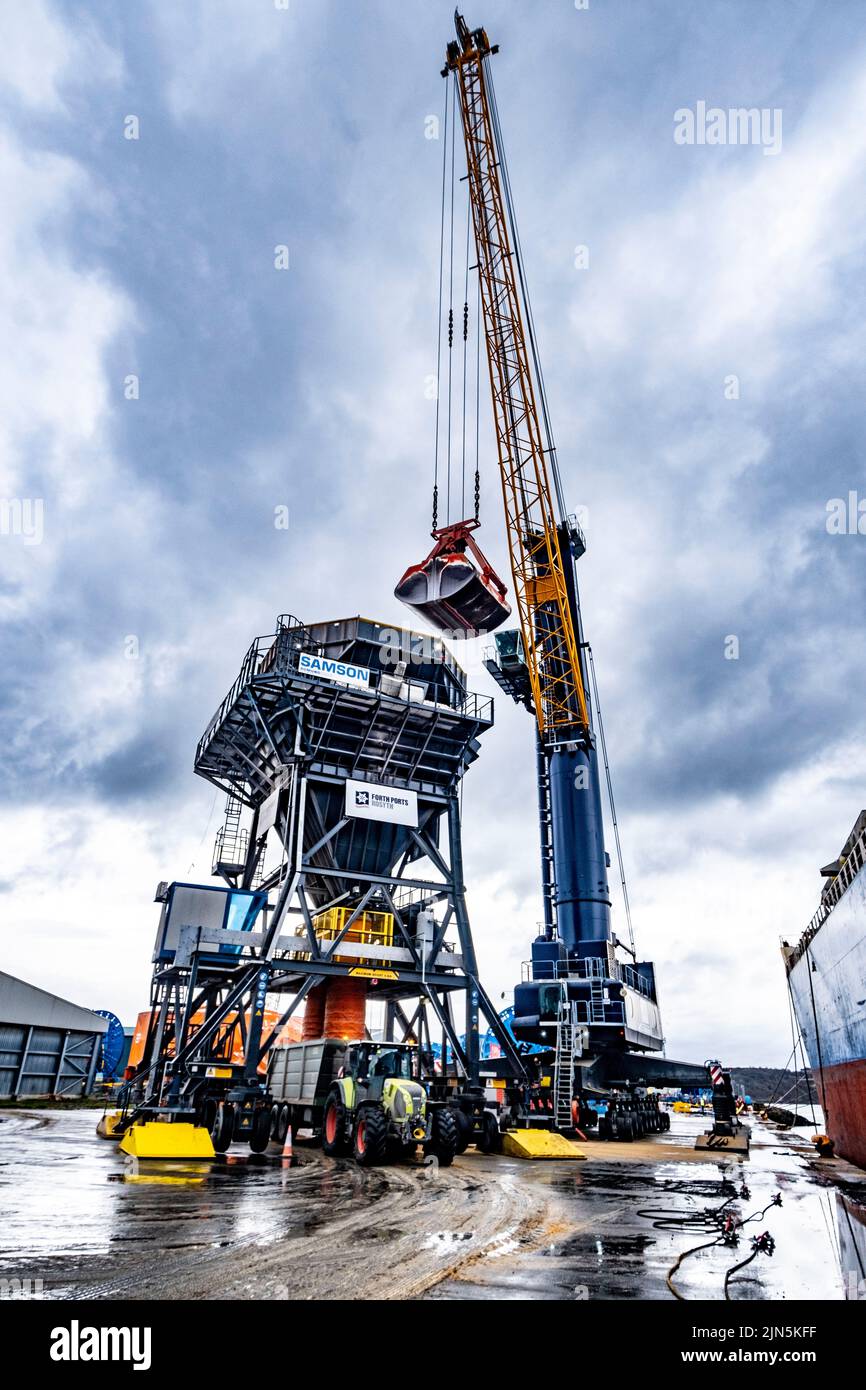Grain being unloaded into a hopper at port Stock Photo - Alamy