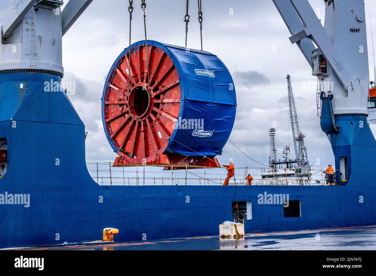 Giant Reels being loaded onto a tanker in port Stock Photo - Alamy