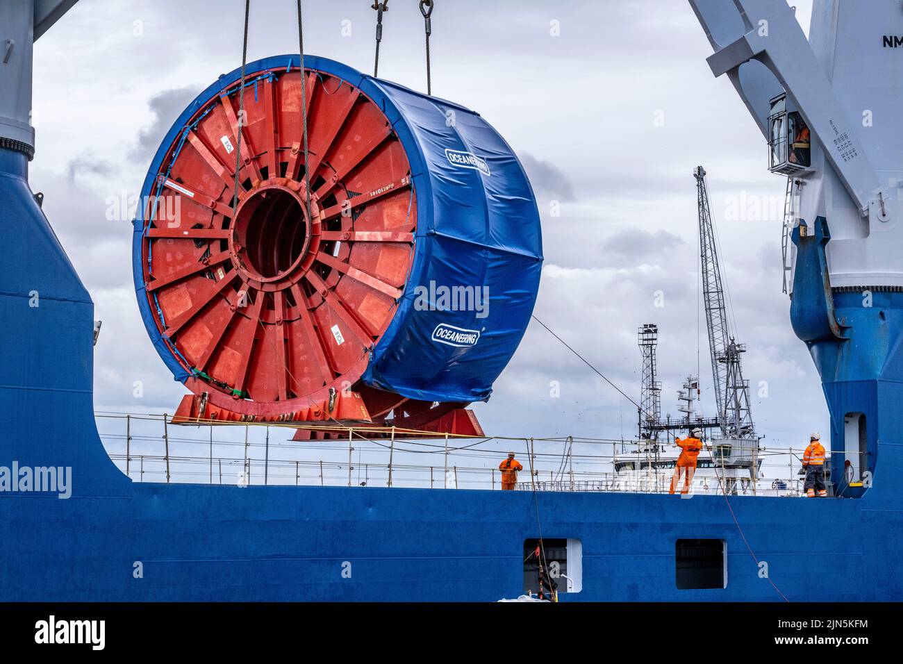 Giant Reels being loaded onto a tanker in port Stock Photo - Alamy