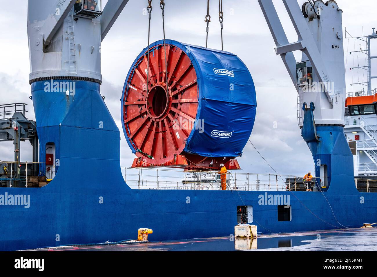 Giant Reels being loaded onto a tanker in port Stock Photo - Alamy