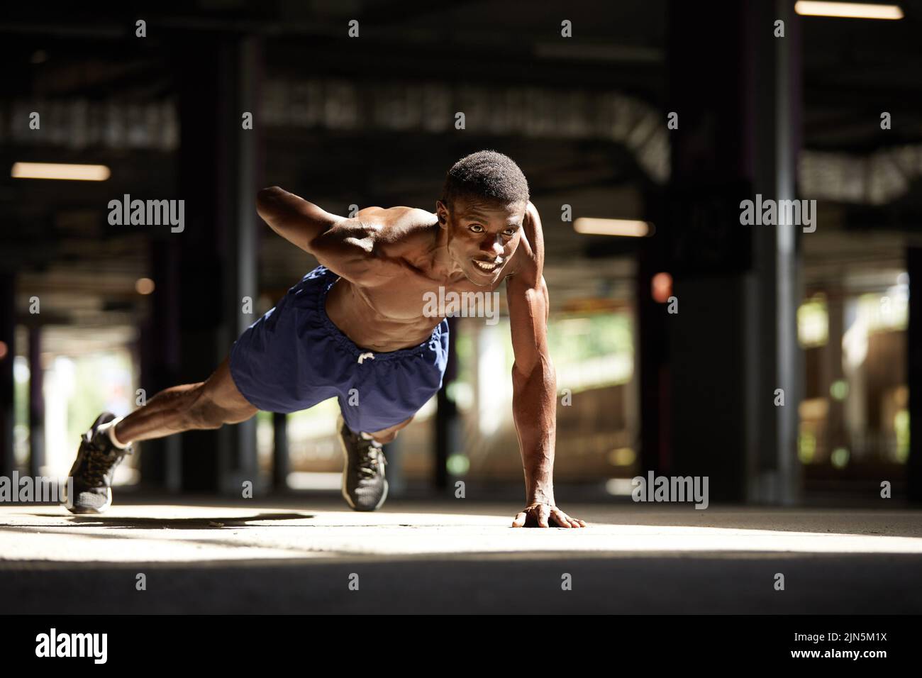 Fitness black man exercising push ups. Male model cross-training in ...