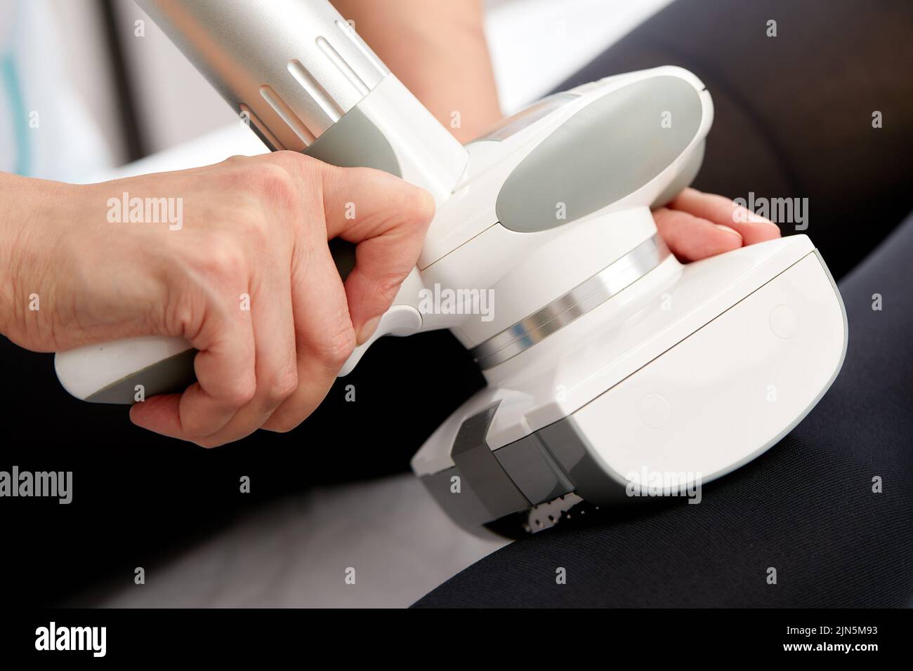 woman in a black suit for LPG massage drinking water before LPG massage ...