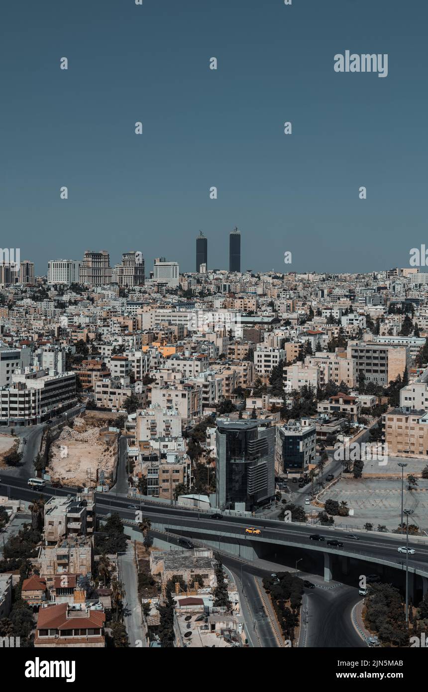 A vertical aerial view of the buildings of Amman during a cloudy day in ...