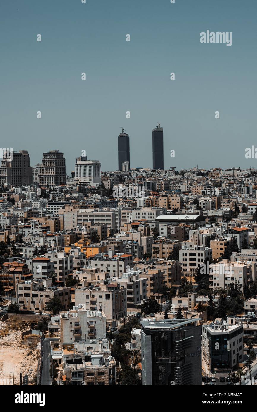 A vertical aerial view of the buildings of Amman during a cloudy day in ...