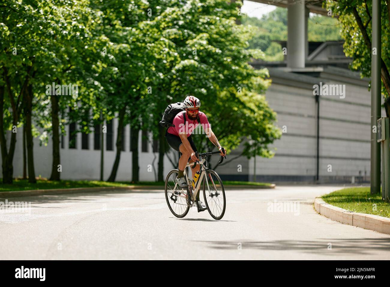 Caucasian handsome young man in protective helmet goes out for bicycle ...