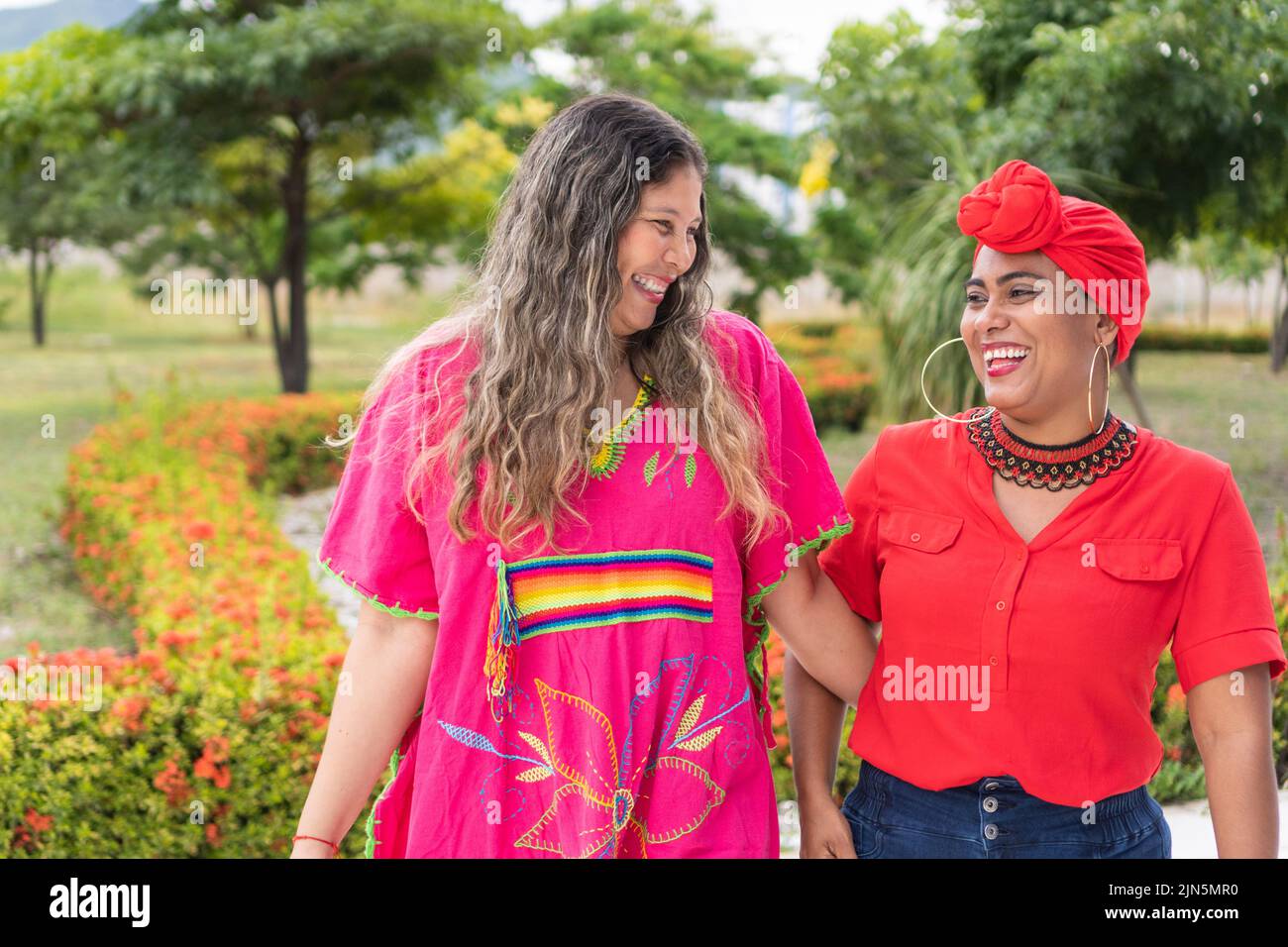 Stock photo of Latina friends walking down the street in the city ...