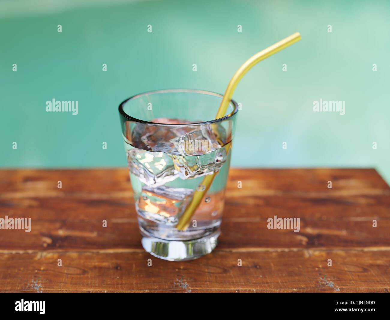 Glass of pure water with ice cubes in tropical environment, 3d ...