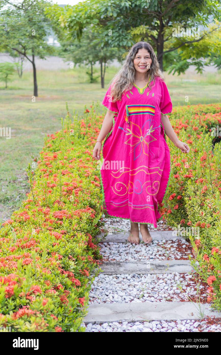 Indigenous woman walking in traditional clothing in the city park Stock ...