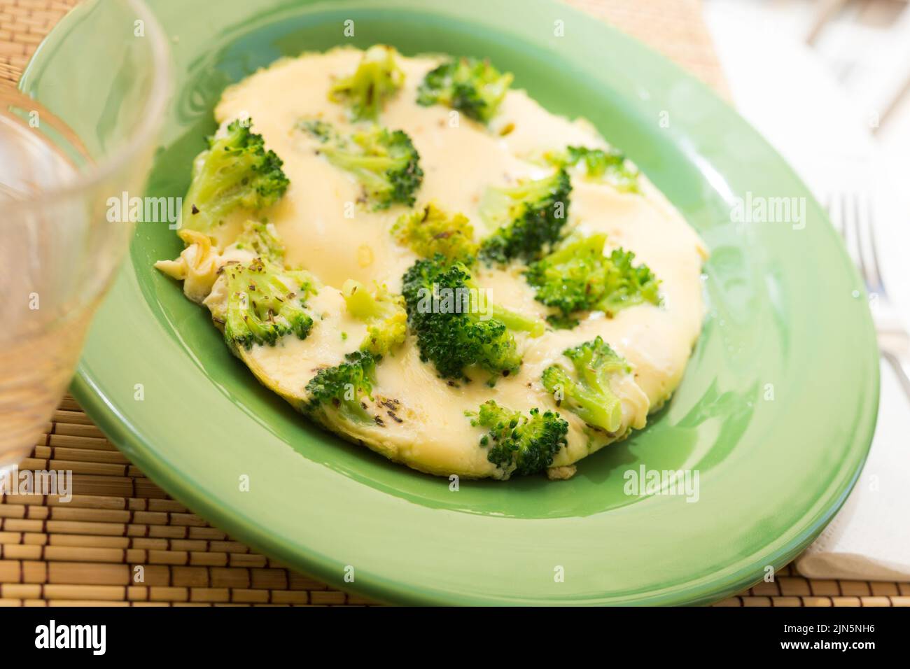 wholesome breakfast. omelet with broccoli on green plate Stock Photo ...