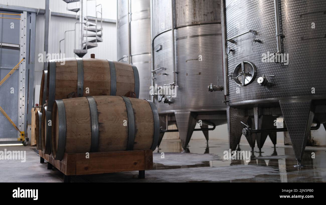Huge tanks in wine cellars and wooden barrels of wine or alcohol Stock ...