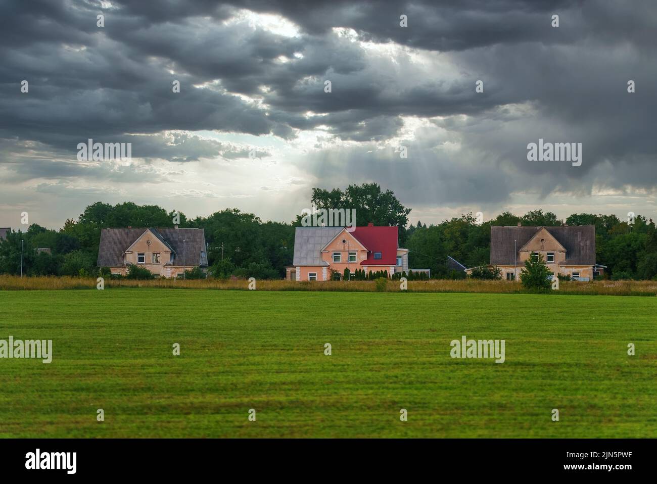 Abandoned village. Three houses in the meadow Stock Photo - Alamy