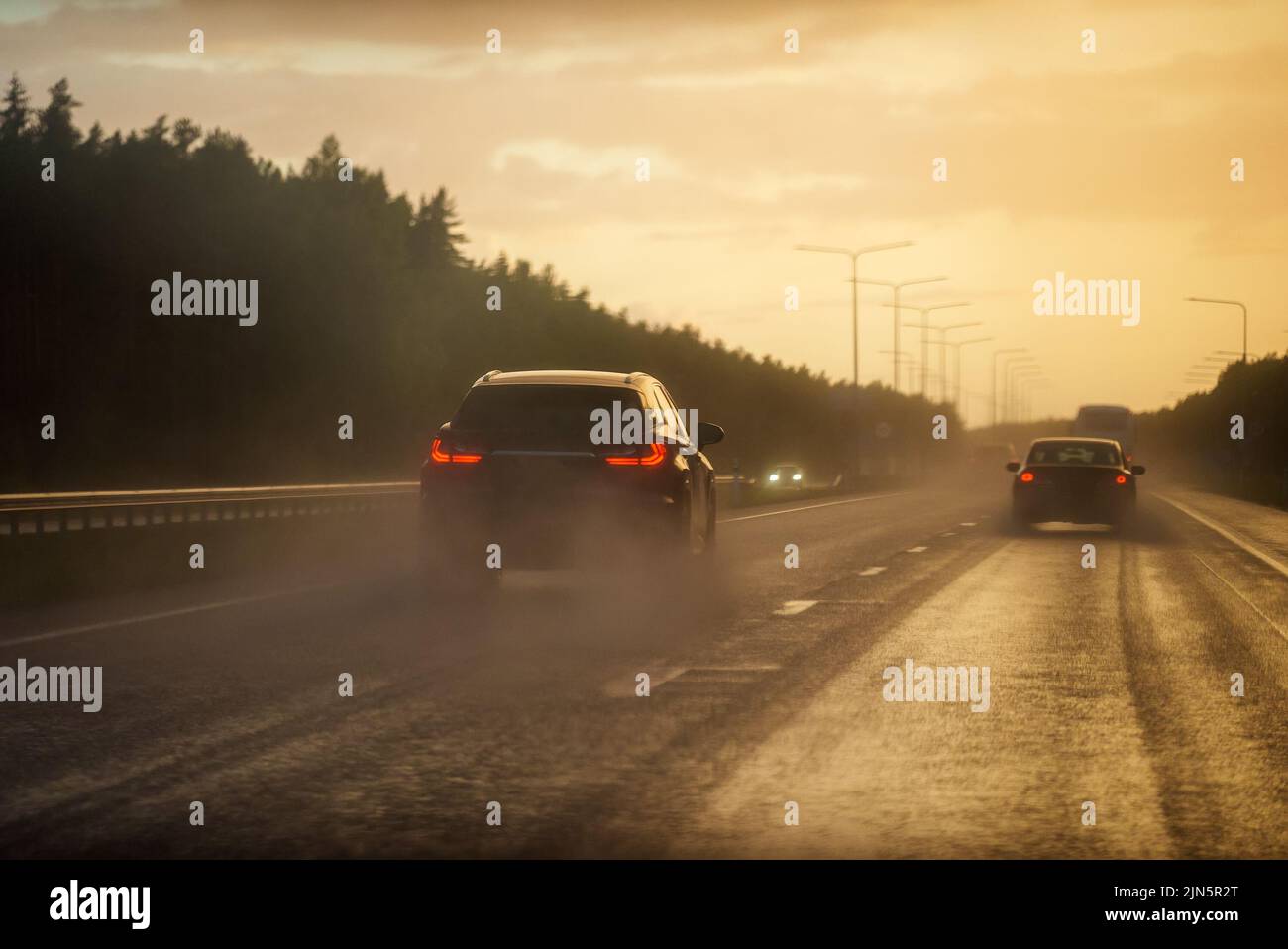 Cars going on the road after the rain Stock Photo - Alamy
